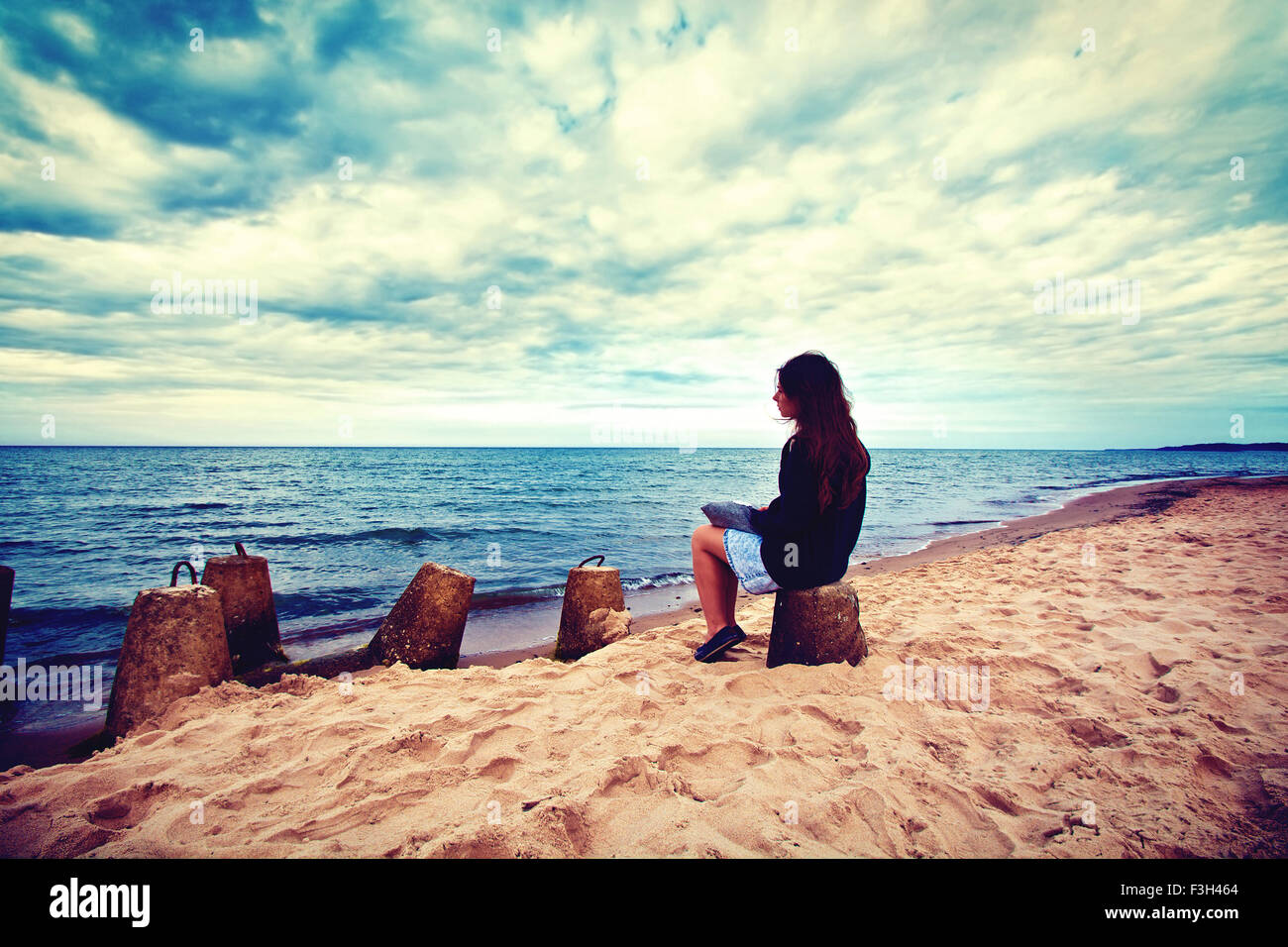 Emotion conceptual image. Sad lonely woman sitting on the beach ...
