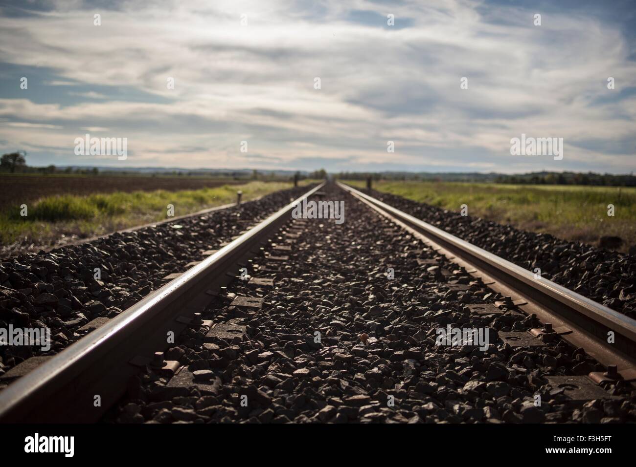 Railway track through countryside Stock Photo - Alamy