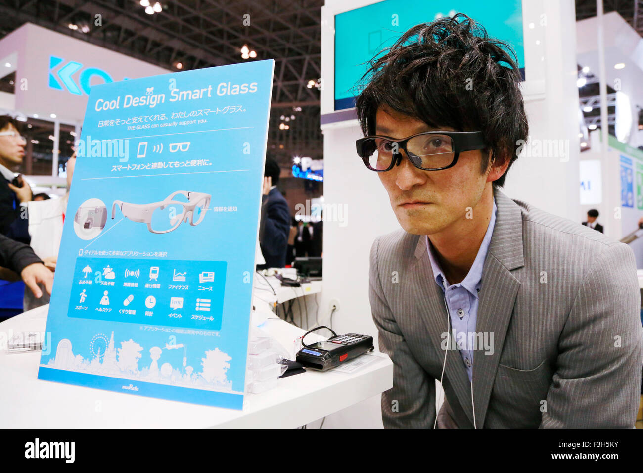 An exhibitor demonstrates Murata's smart glass concept model ''Cool ...