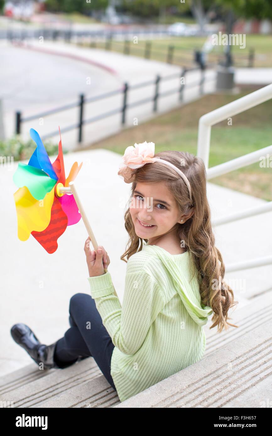Girl with paper windmill in park Stock Photo - Alamy