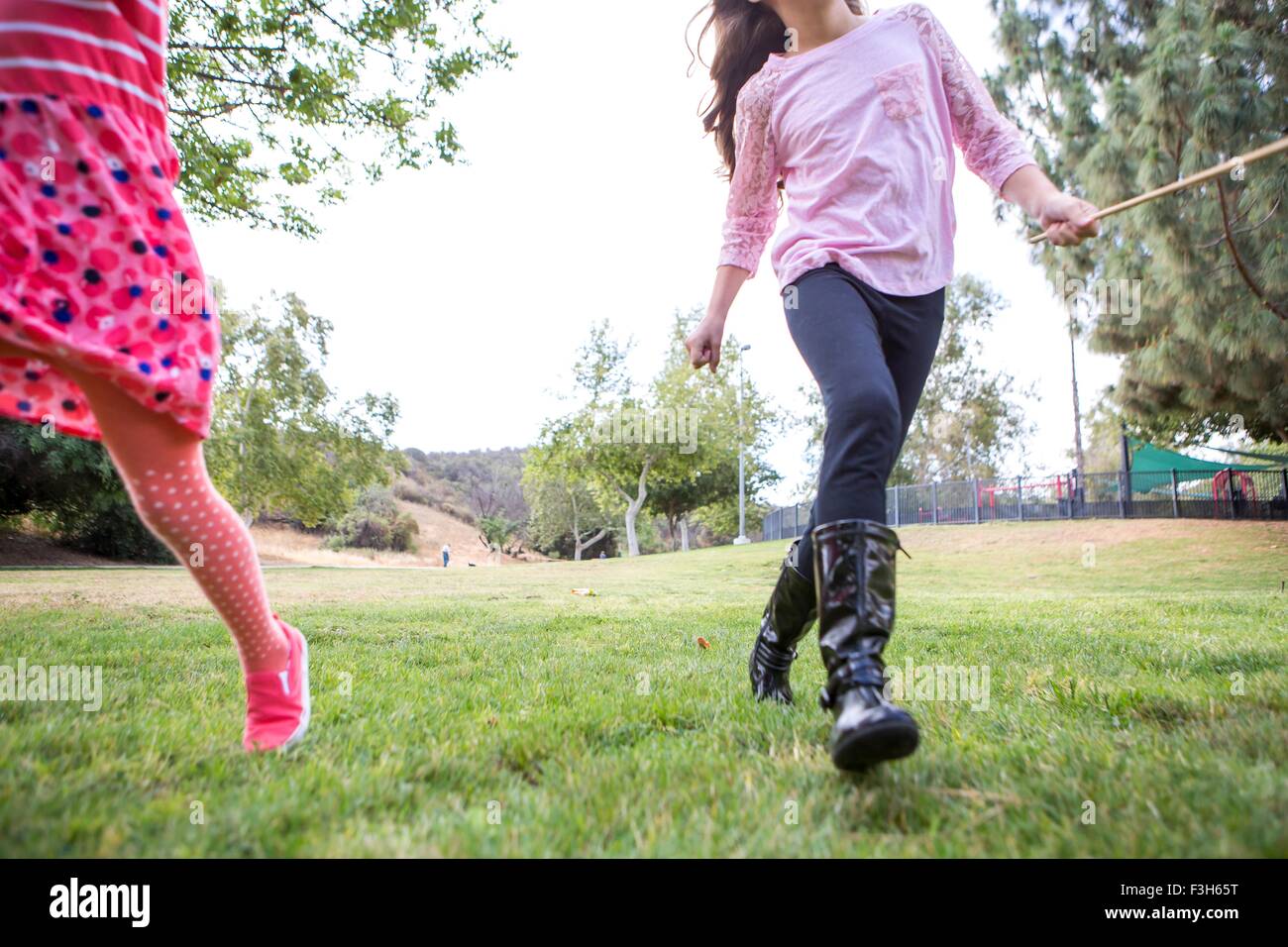 Girls playing in park Stock Photo - Alamy