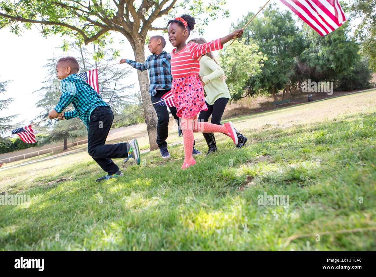 Children playing with American flag in park Stock Photo - Alamy