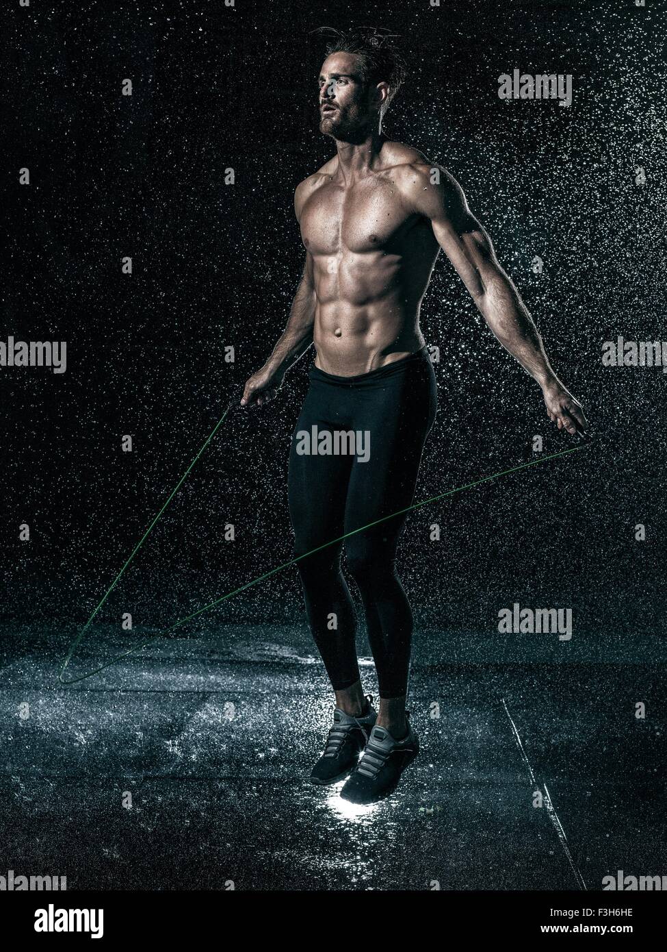 MId adult man, outdoors, skipping in rain Stock Photo - Alamy