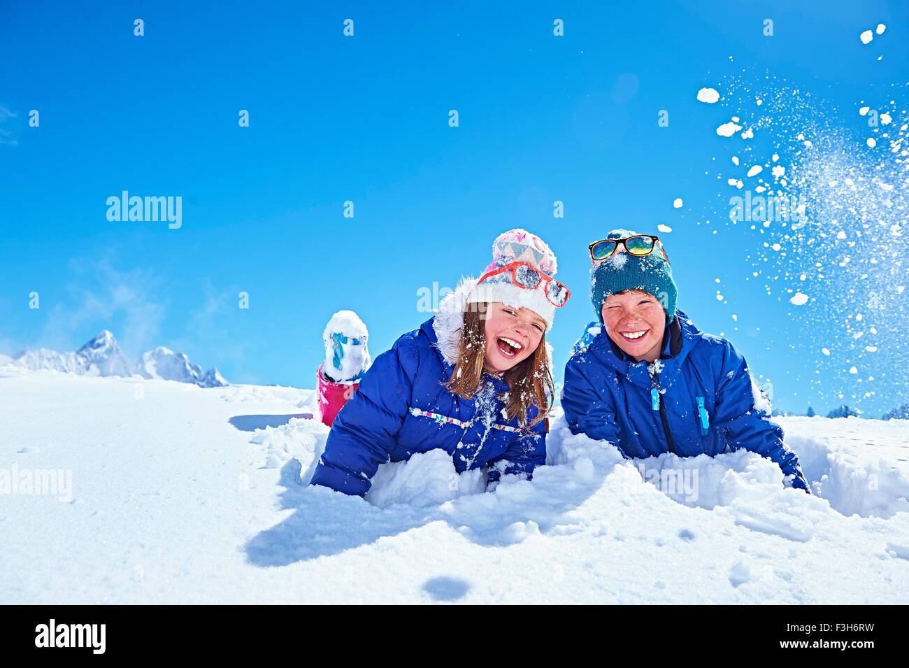 Siblings playing in snow, Chamonix, France Stock Photo - Alamy