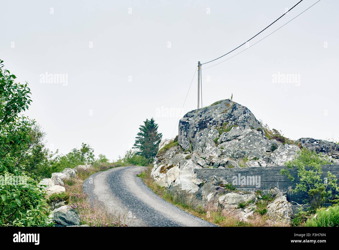 Empty road curving around rocky outcrop, Haugesund, Rogaland County ...