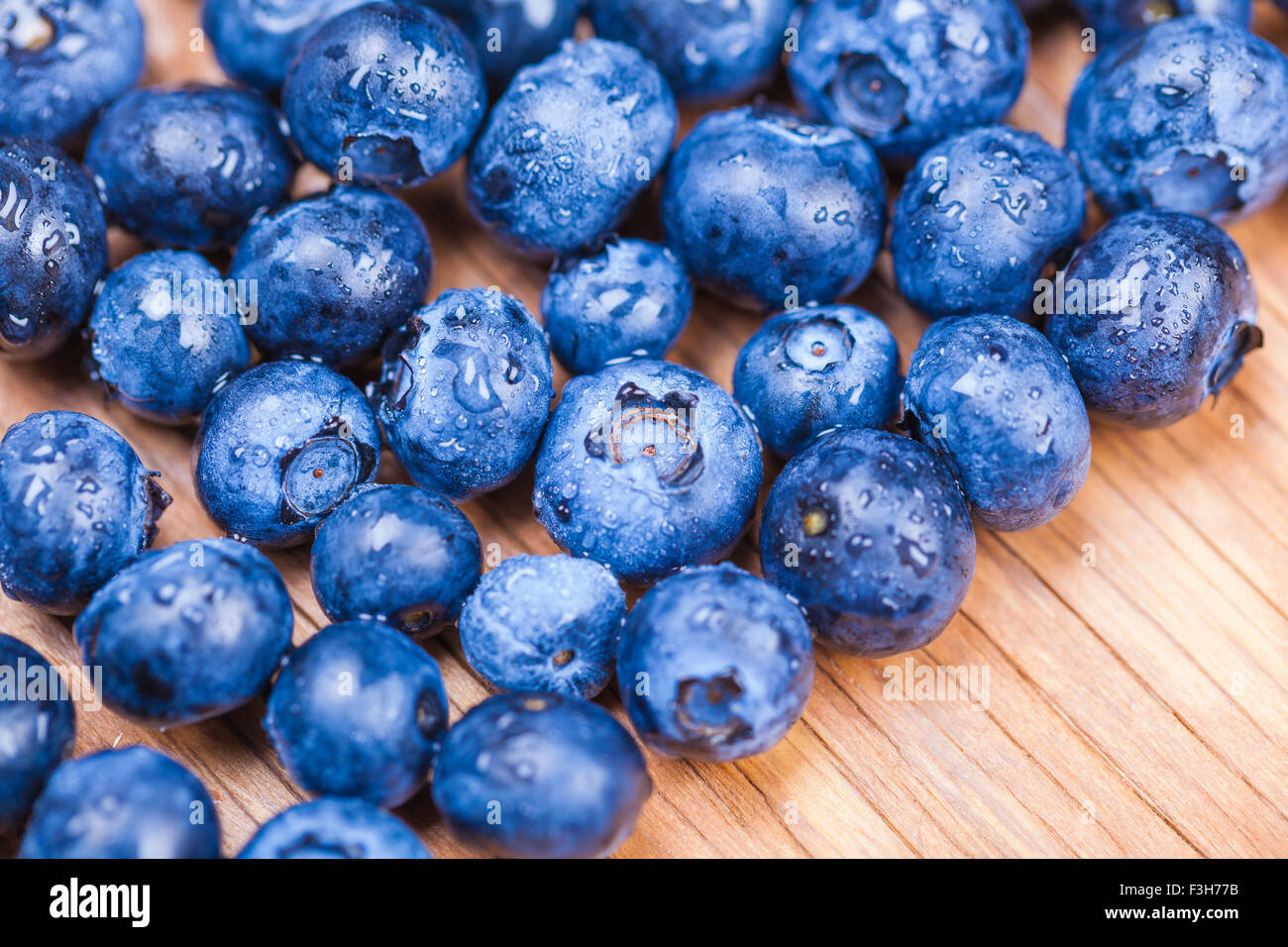 natural fresh blueberries closeup on wooden background Stock Photo - Alamy