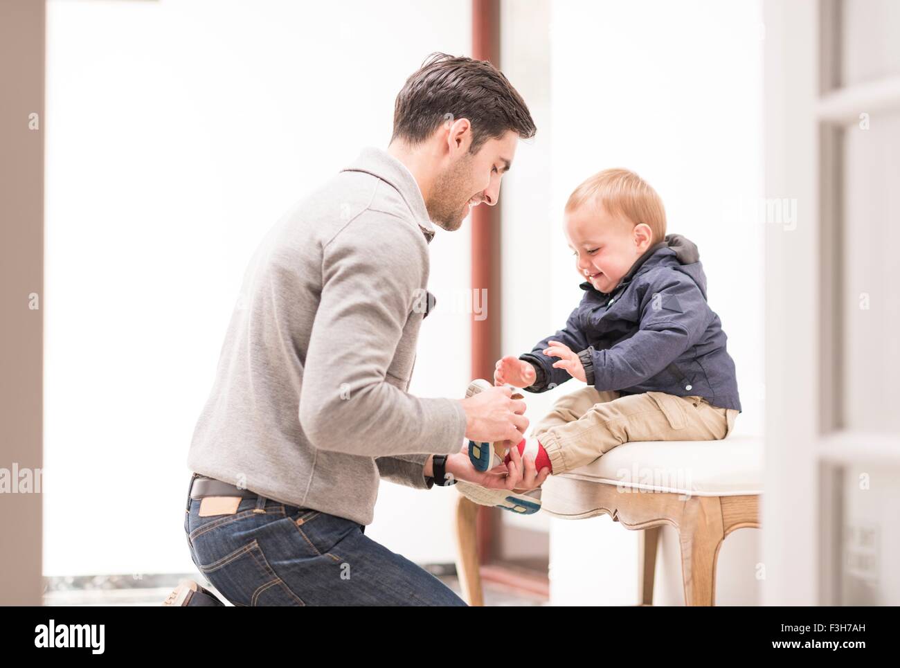 Father helping young son put shoes on Stock Photo - Alamy Father helping young son put shoes on Stock Photo - Alamy