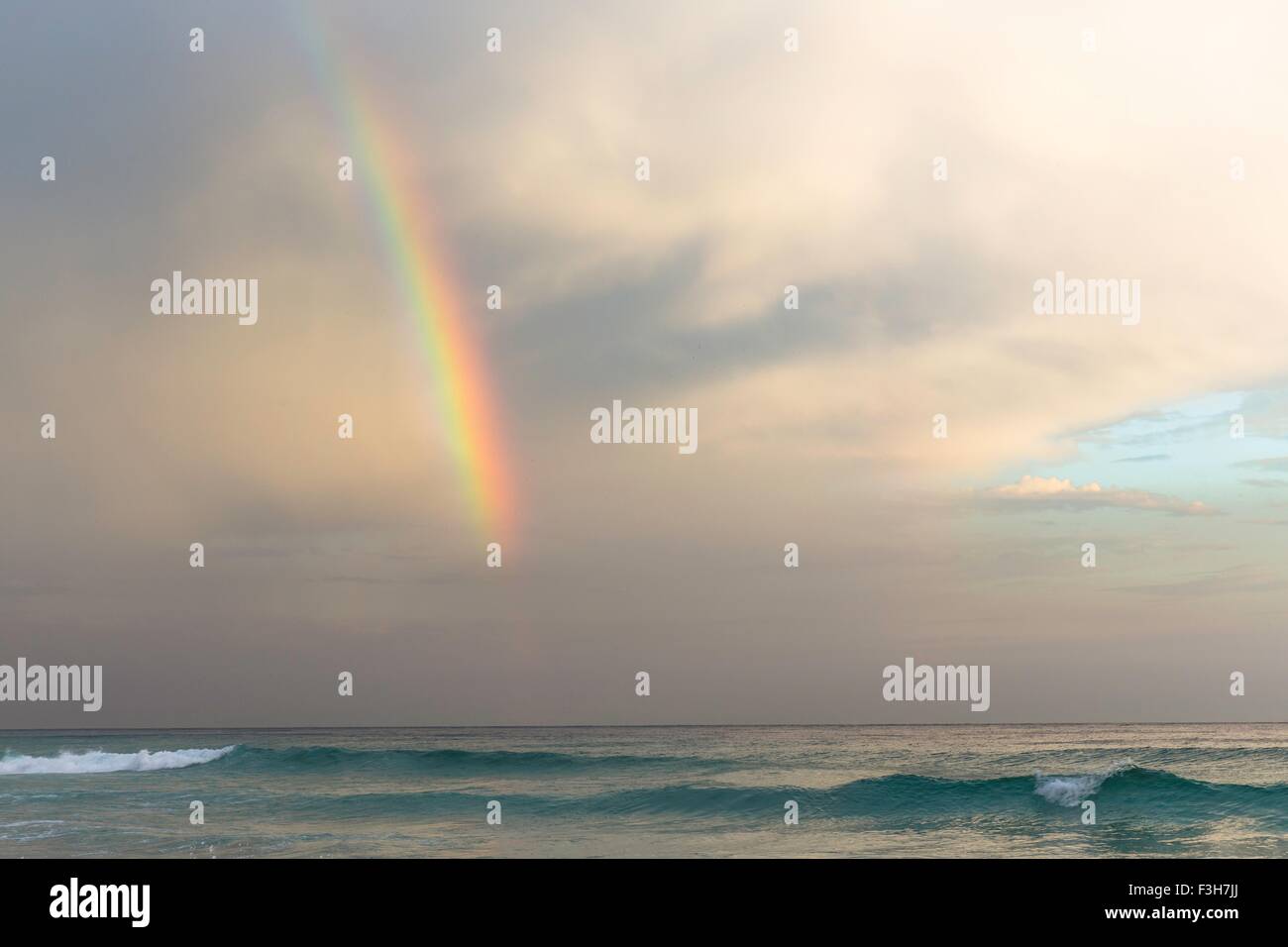 Rainbow over ocean in cloudy sky, Rio De Janeiro, Brazil Stock Photo ...