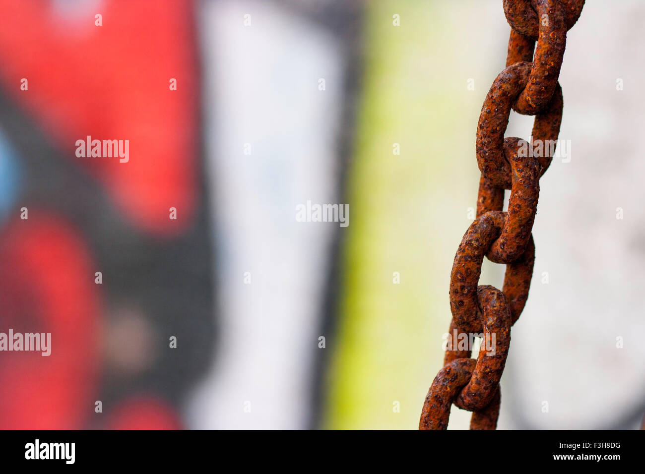 Rusty chain with graffiti background Stock Photo - Alamy