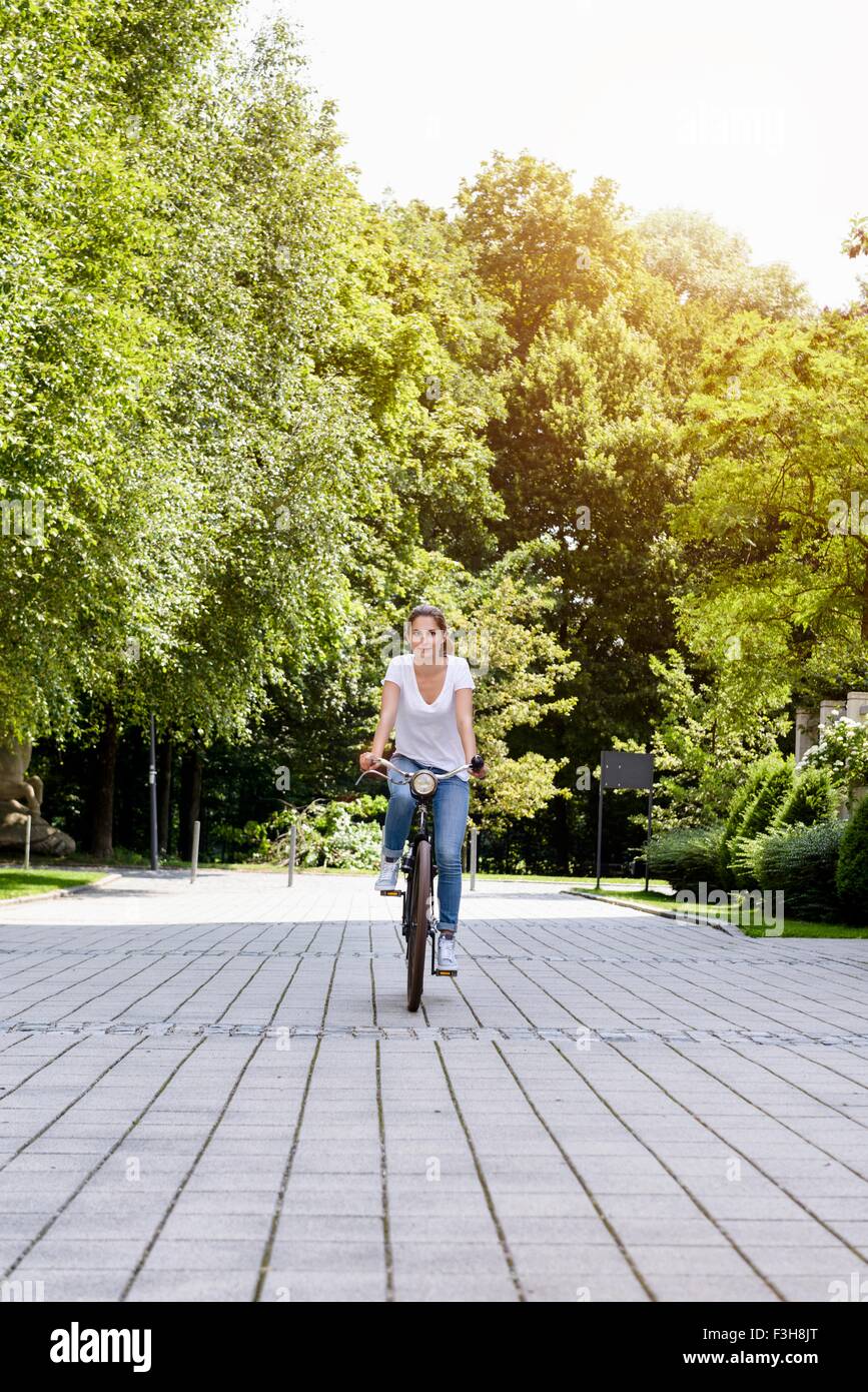 Woman riding bicycle looking at camera hi-res stock photography and ...