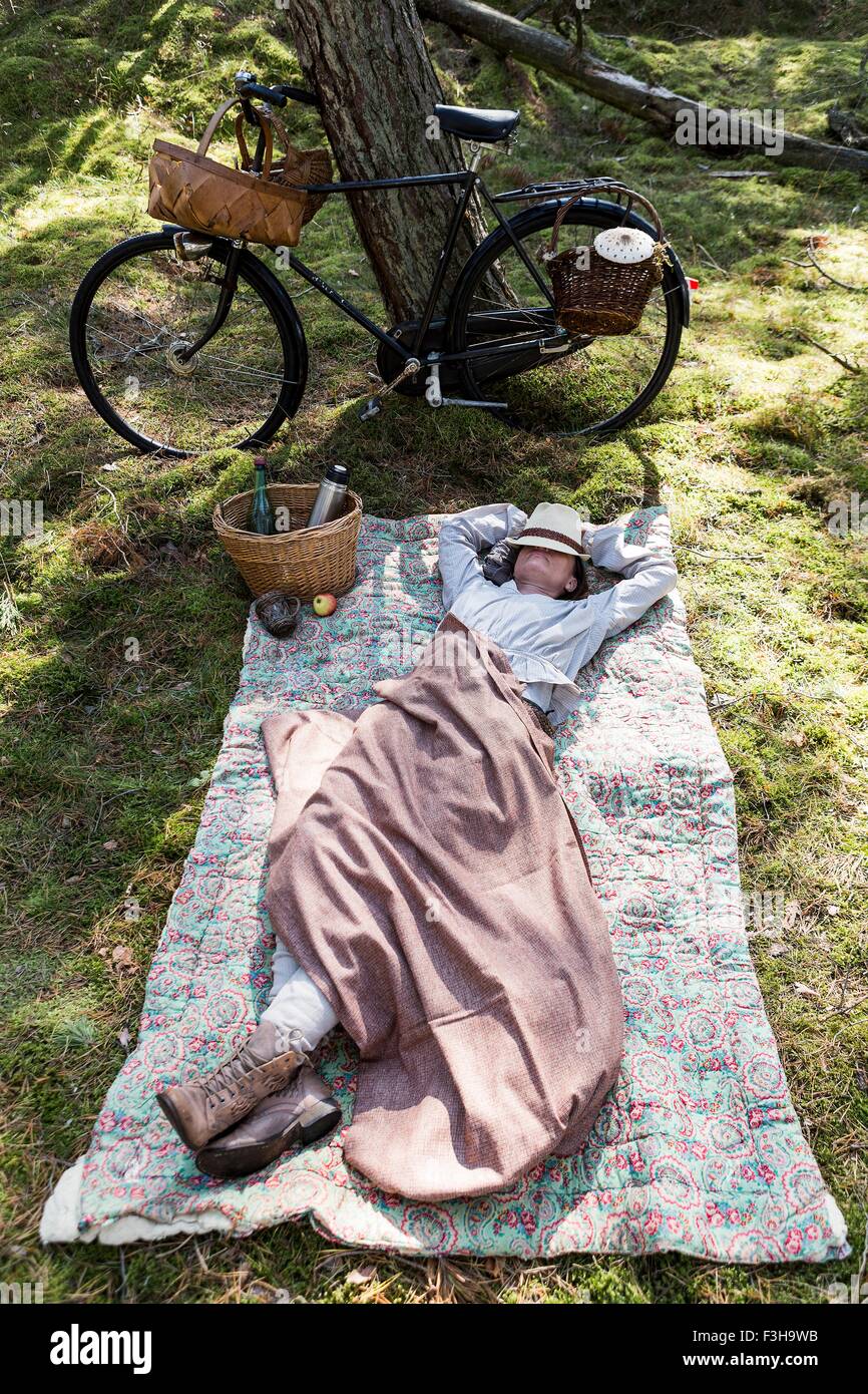 Mature female forager resting on blanket in forest Stock Photo - Alamy