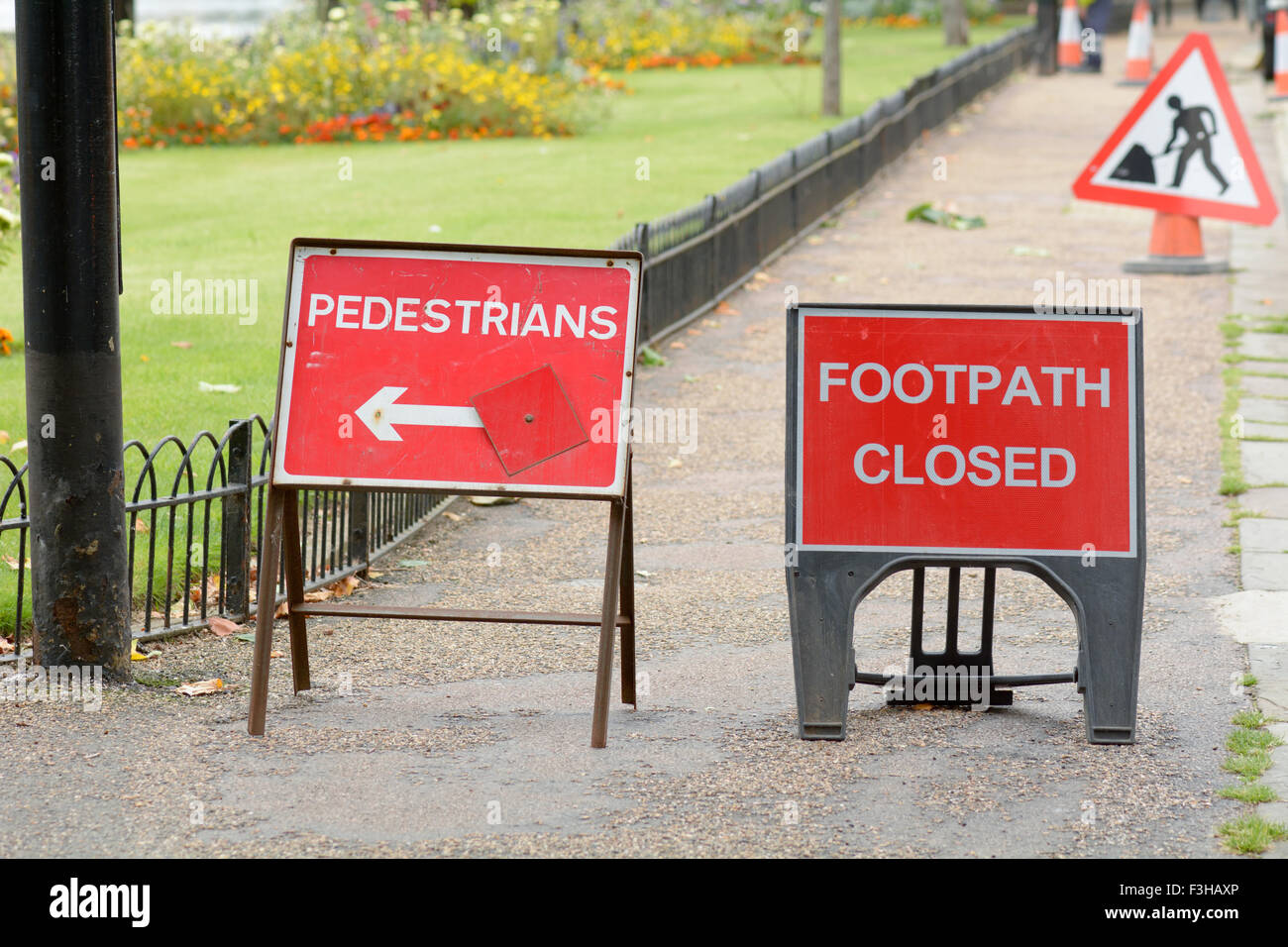 'Footpath Closed' and 'Pedestrians' this way with direction arrow signs ...