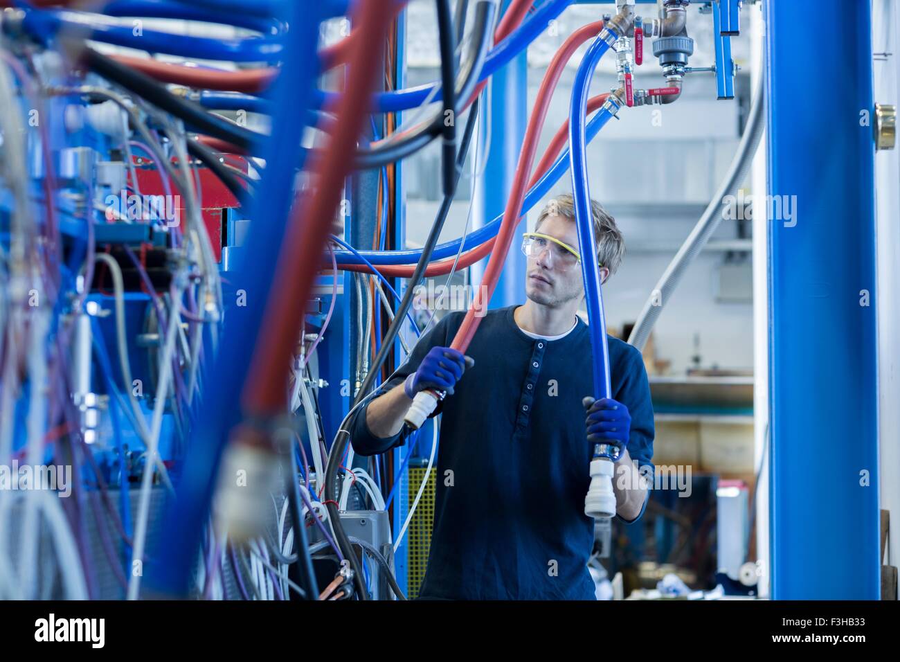 Factory technician inspecting network cables Stock Photo - Alamy