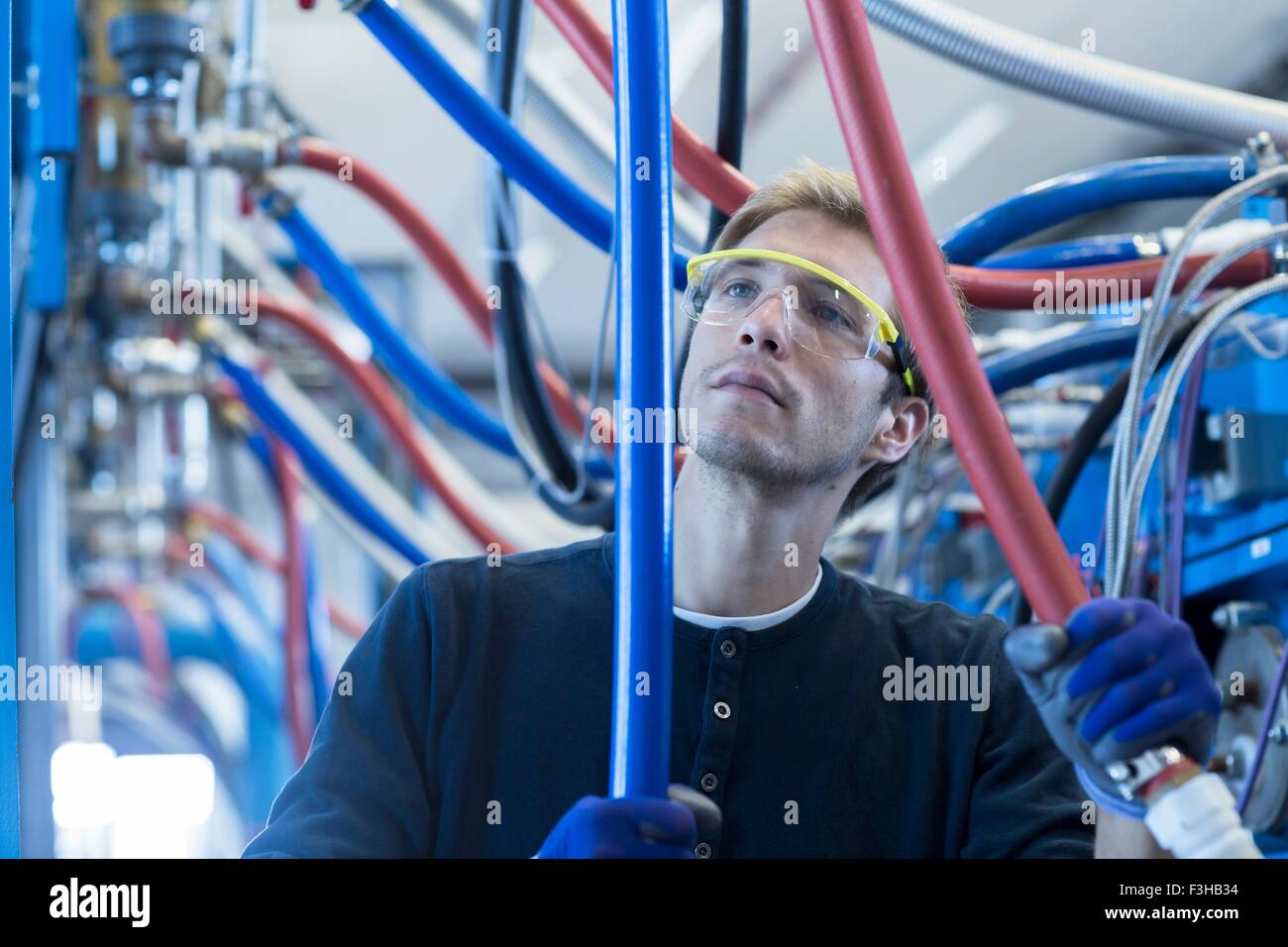 Factory technician checking network cables Stock Photo - Alamy
