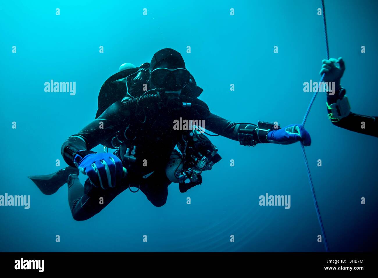 Underwater view of technical diver using a rebreather device to locate ...