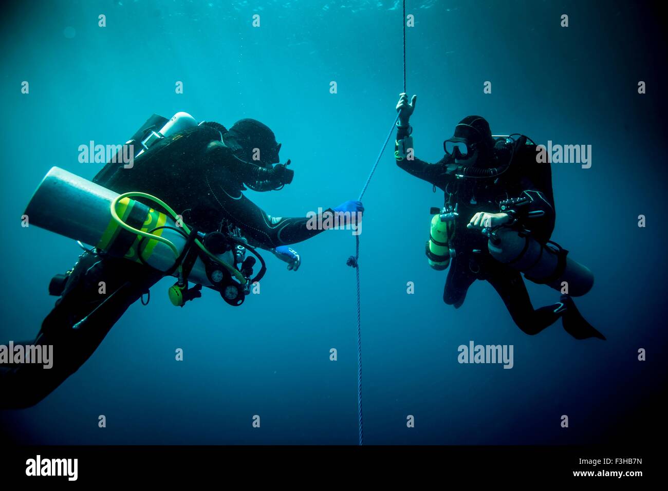 Underwater view of two technical divers using rebreathers device to ...