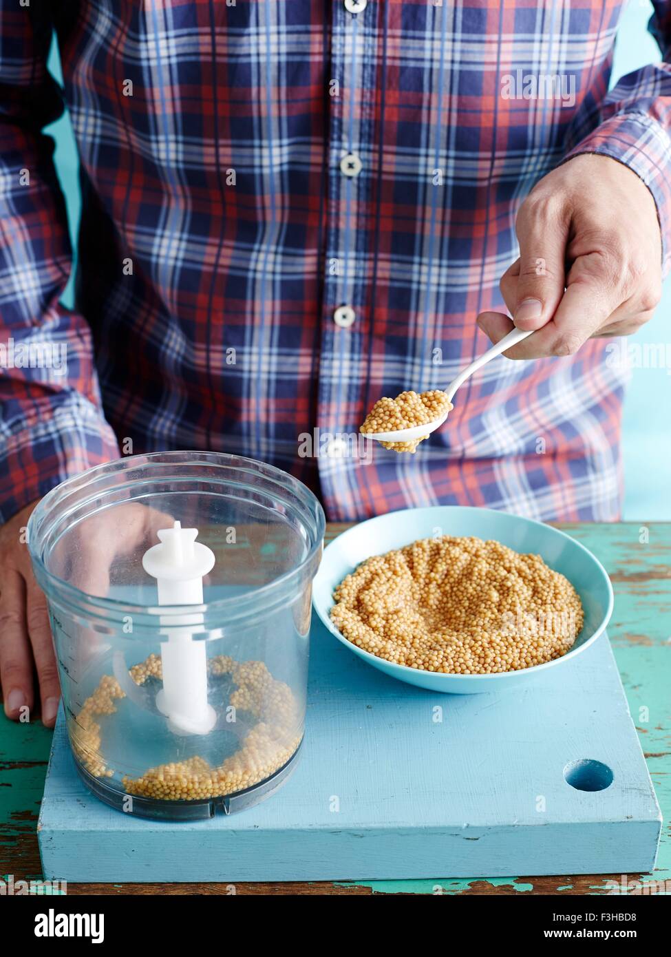 Man preparing fresh mustard recipe step 1, mustard seeds in food ...