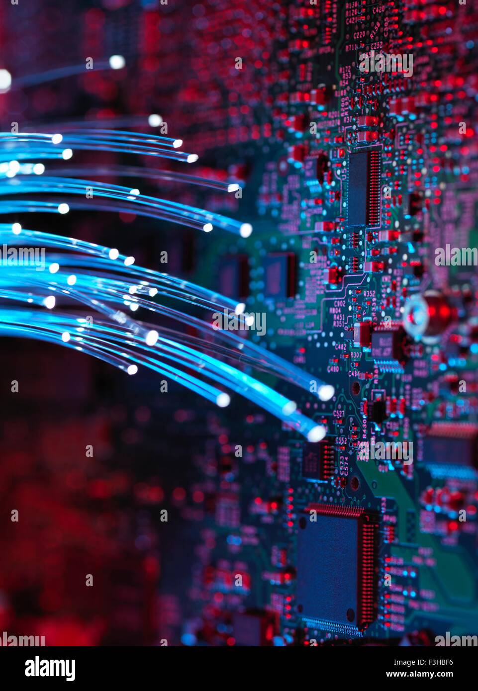 Fibre optics flowing through circuit boards from a laptop computer ...