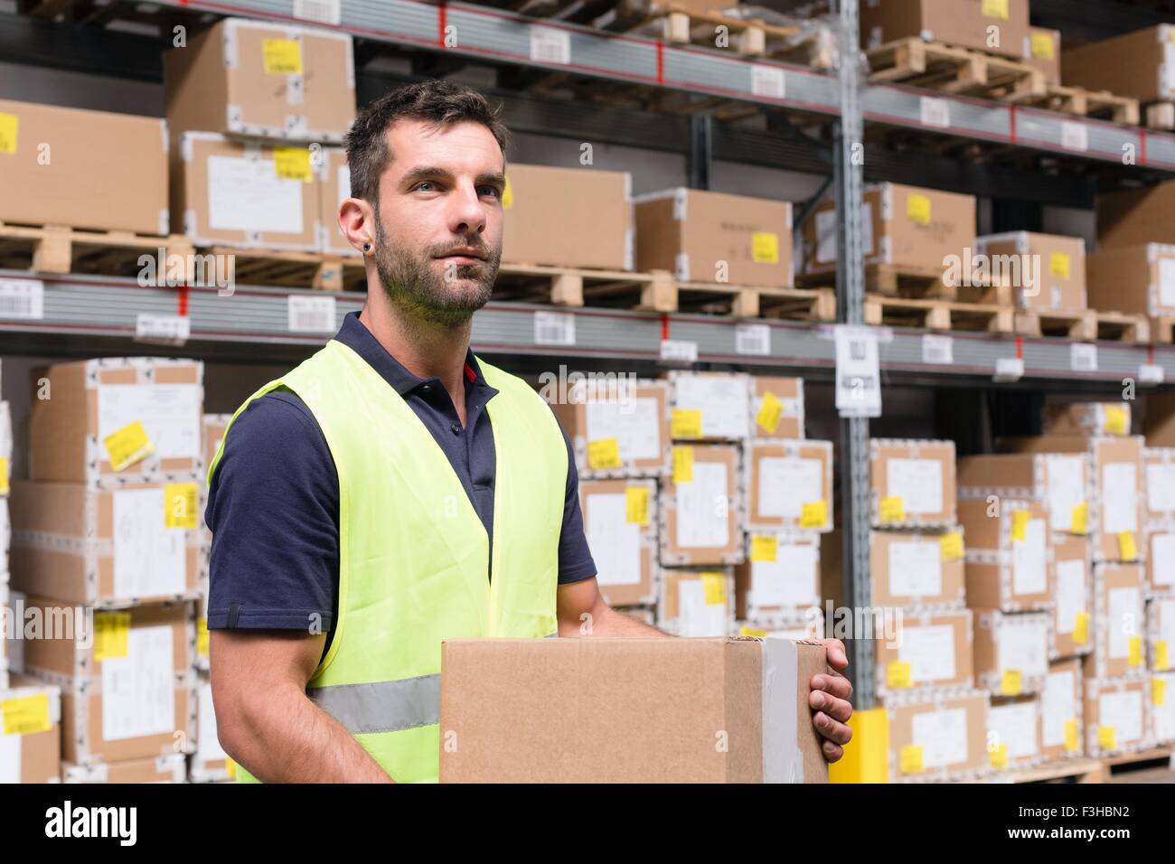 Male warehouse worker preparing order in distribution warehouse Stock ...