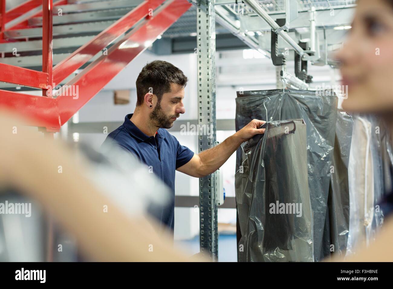 Warehouse workers collecting garment orders in distribution warehouse ...