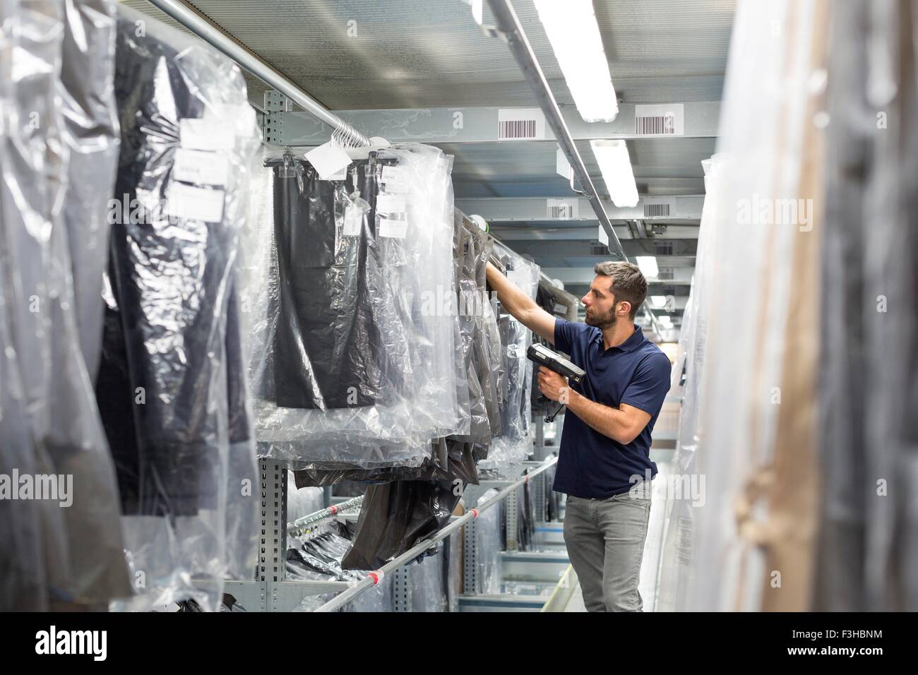 Warehouse worker stock taking in distribution warehouse Stock Photo - Alamy