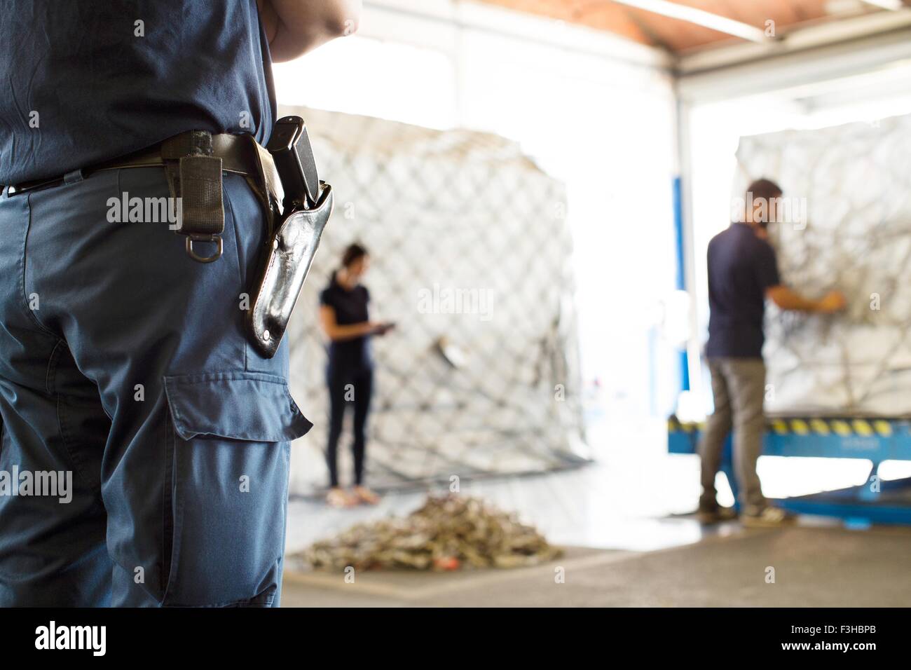 Security guard watching workers in air freight warehouse Stock Photo ...