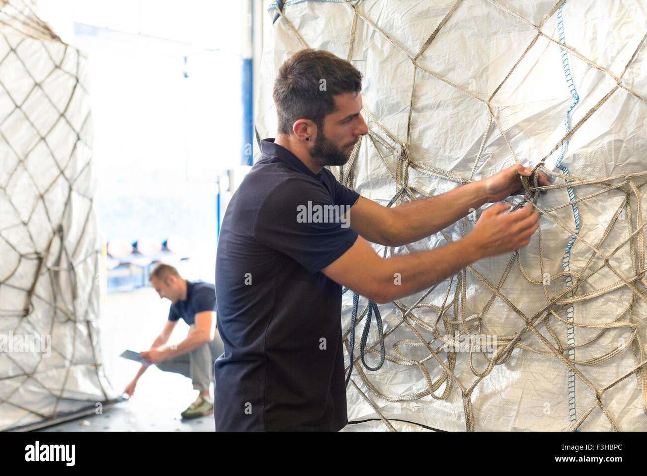 Workers preparing freight in air freight warehouse Stock Photo - Alamy