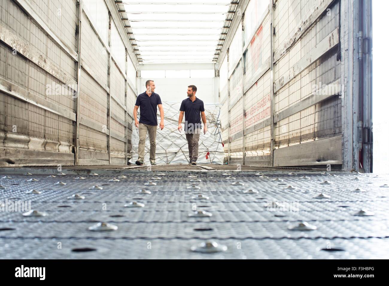 Workers and freight in air freight container Stock Photo - Alamy