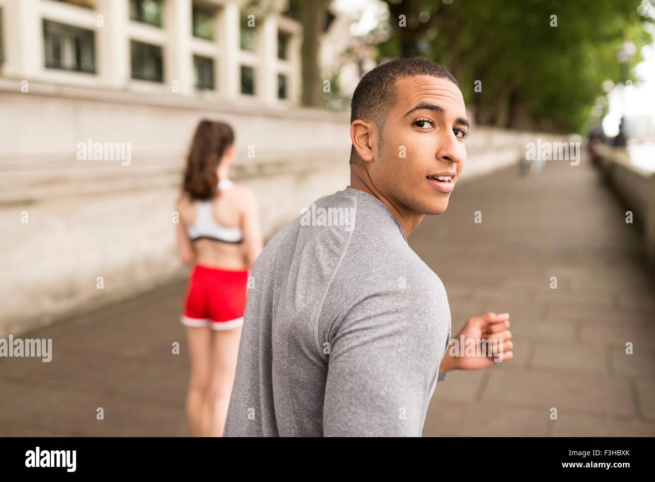 Man looking over shoulder running hi-res stock photography and images ...