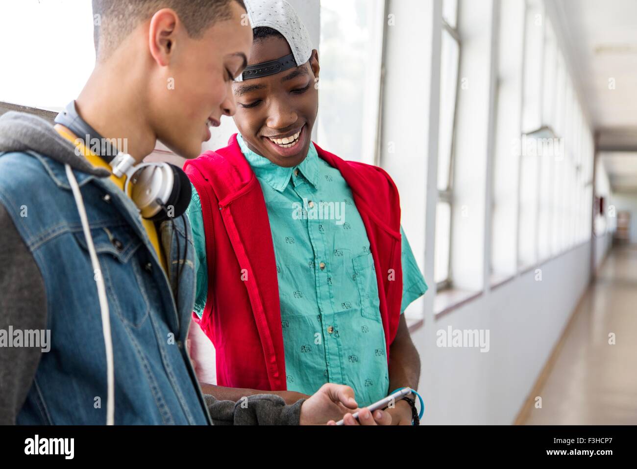 Students standing in hallway, using smartphone Stock Photo - Alamy