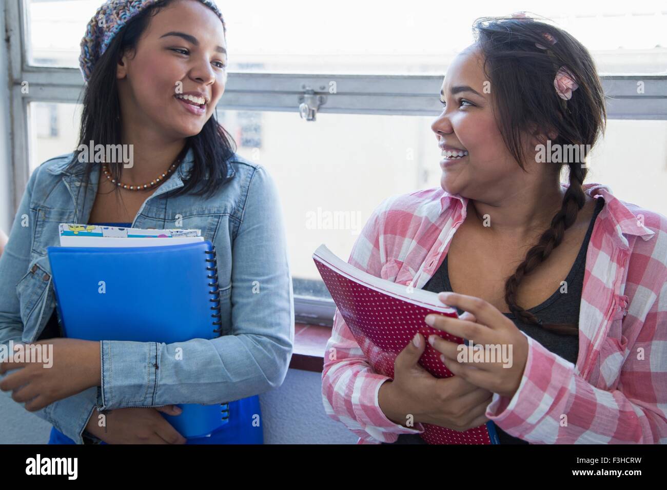 Students standing by window, chatting Stock Photo - Alamy