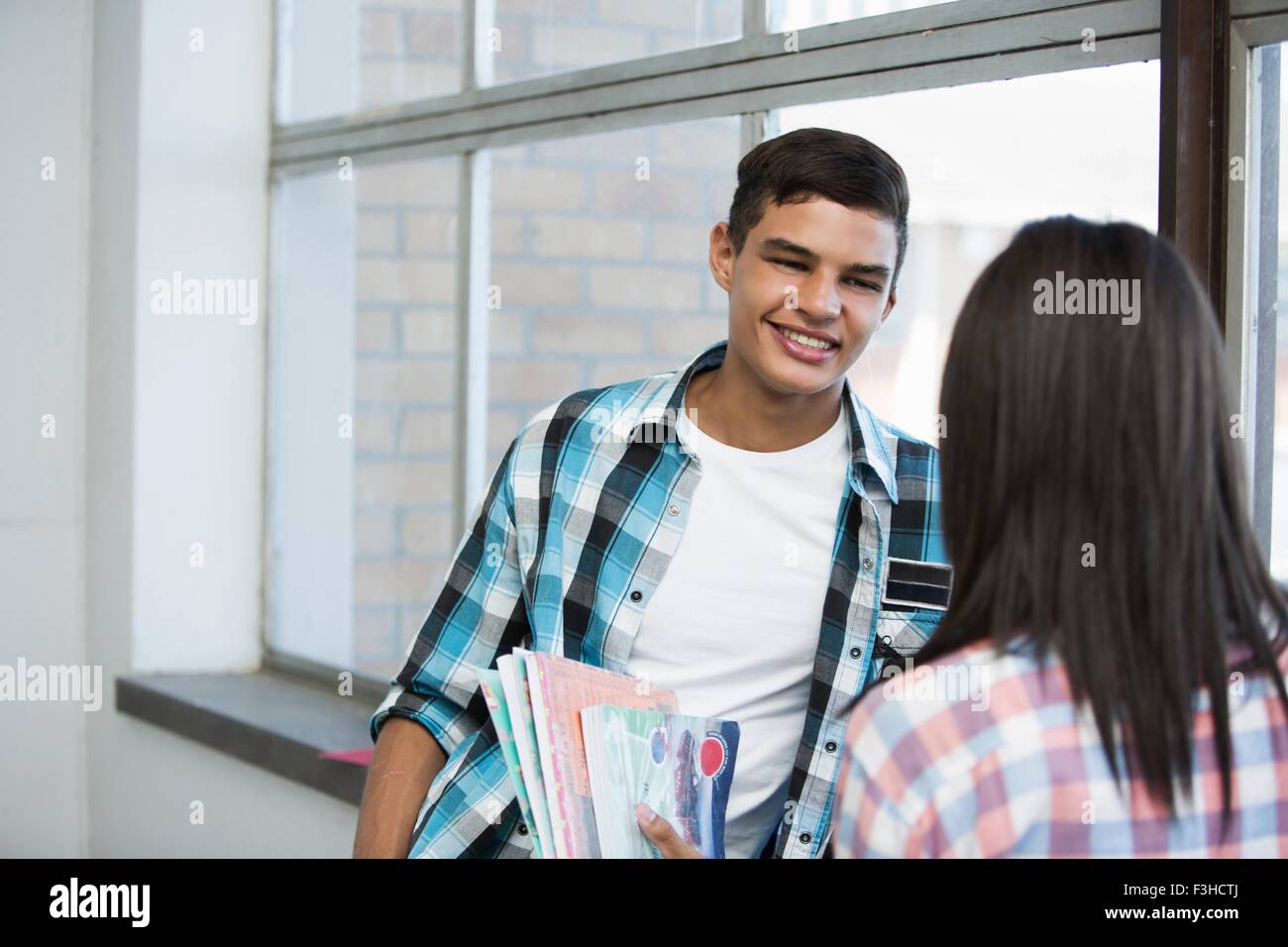 Students standing by window, chatting Stock Photo - Alamy