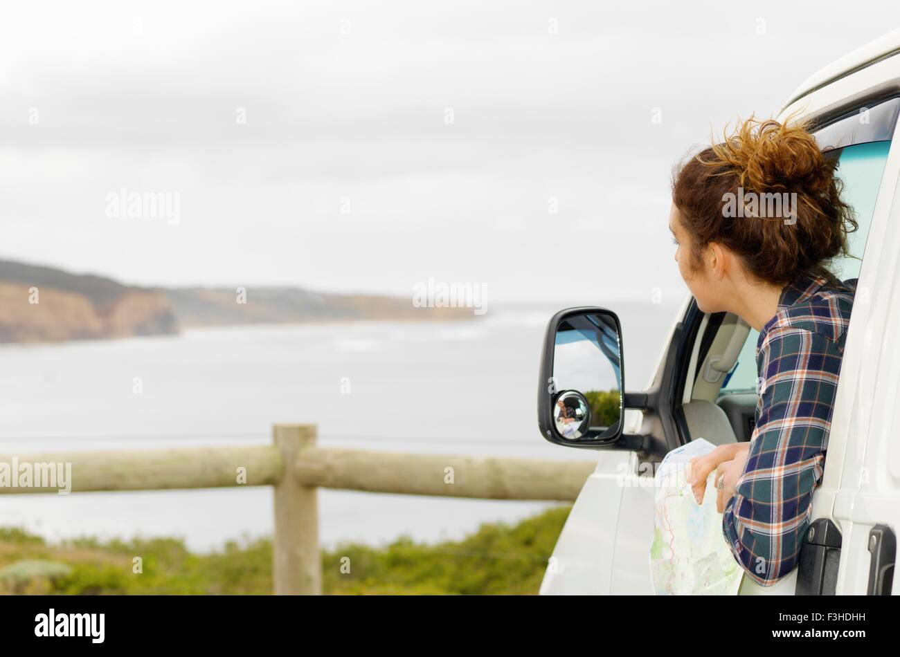 Young woman looking out from camper van window, Point Addis, Anglesea ...