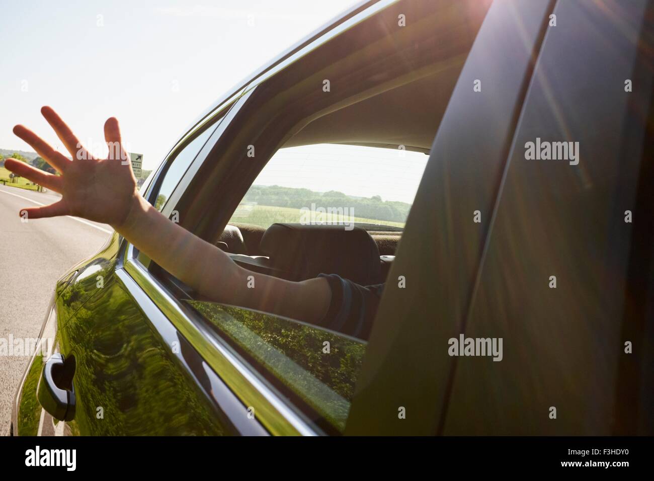 Boys hand outside moving car window Stock Photo - Alamy