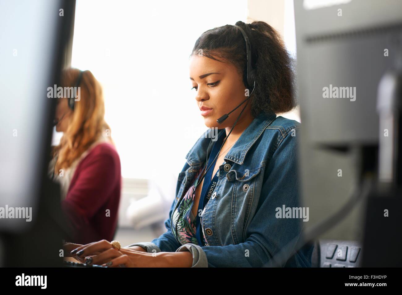 Female students typing on desktop computer in classroom Stock Photo - Alamy