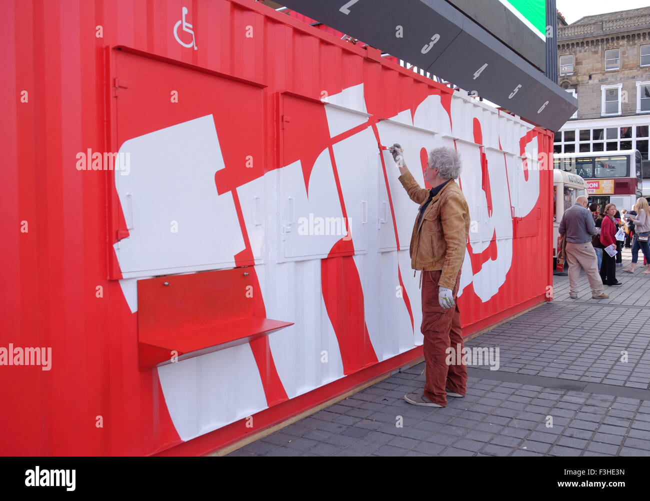A painter puts the finishing touches to a Fringe Box Office on The ...