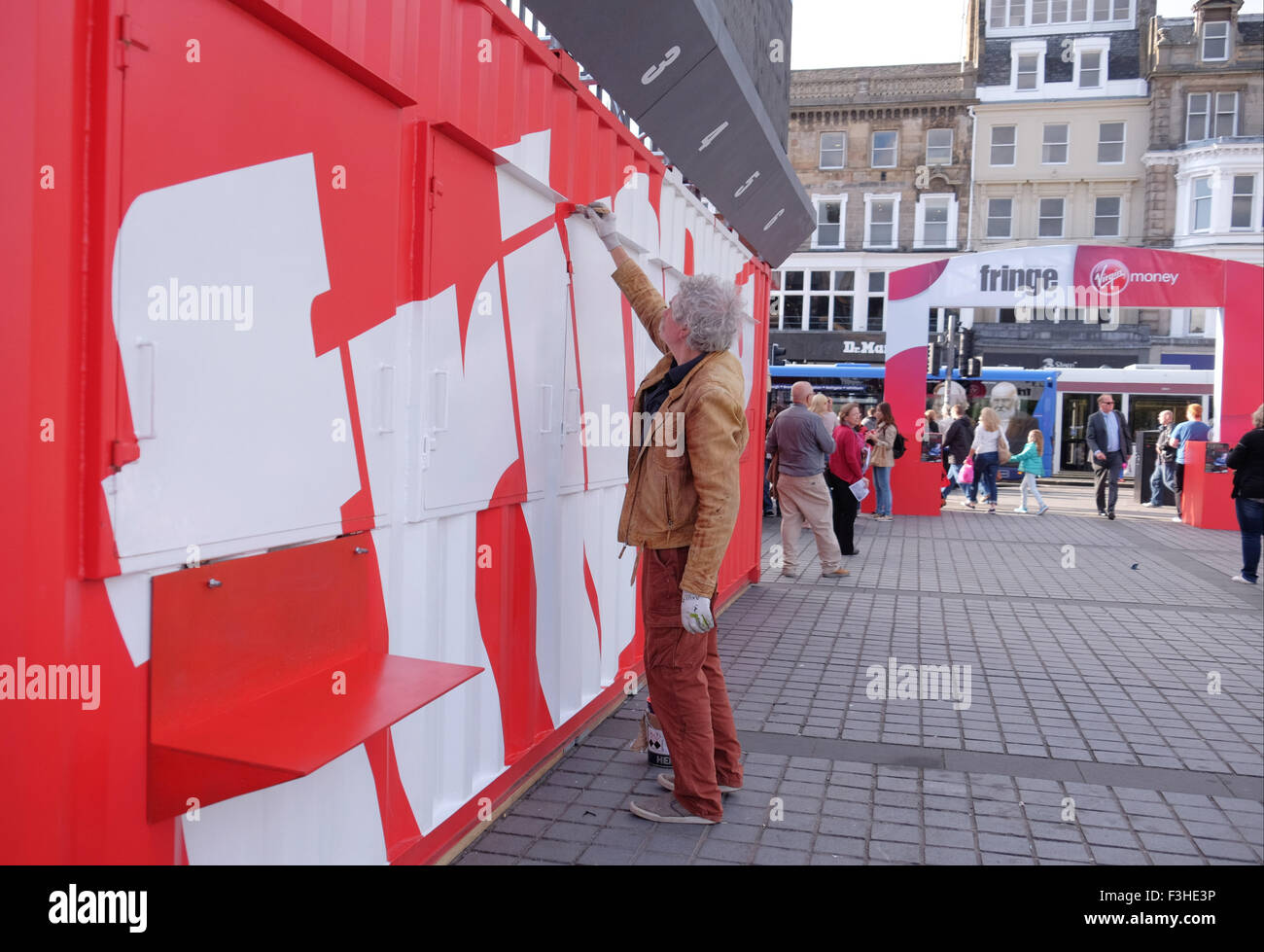 A painter puts the finishing touches to a Fringe Box Office on The ...