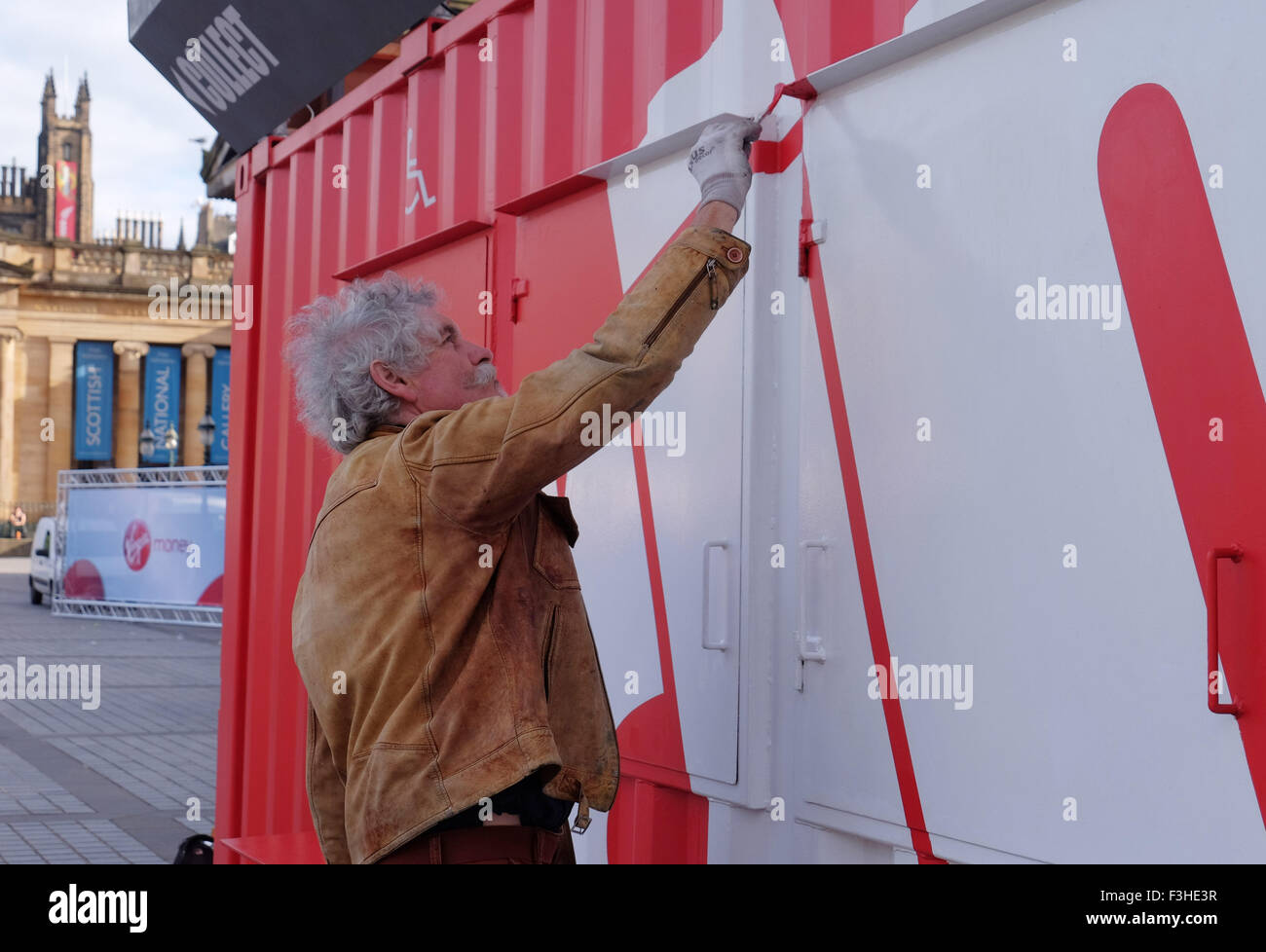 A painter puts the finishing touches to a Fringe Box Office on The ...
