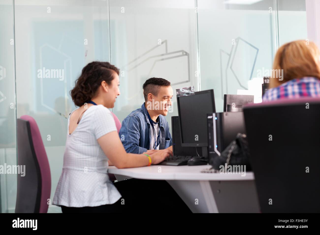 Group of students working together in computer class Stock Photo - Alamy