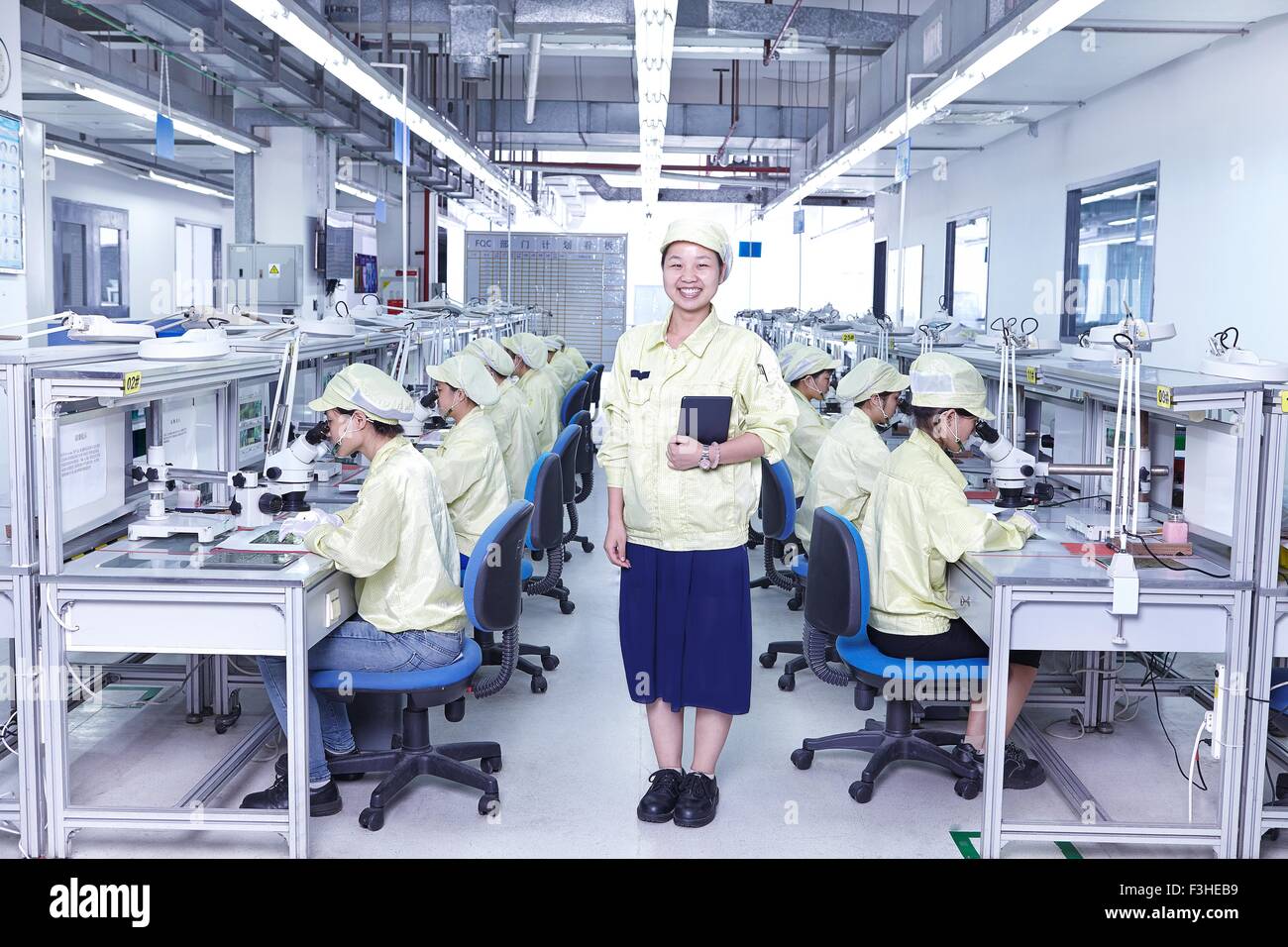 Supervisor overseeing quality check station factory producing flexible ...