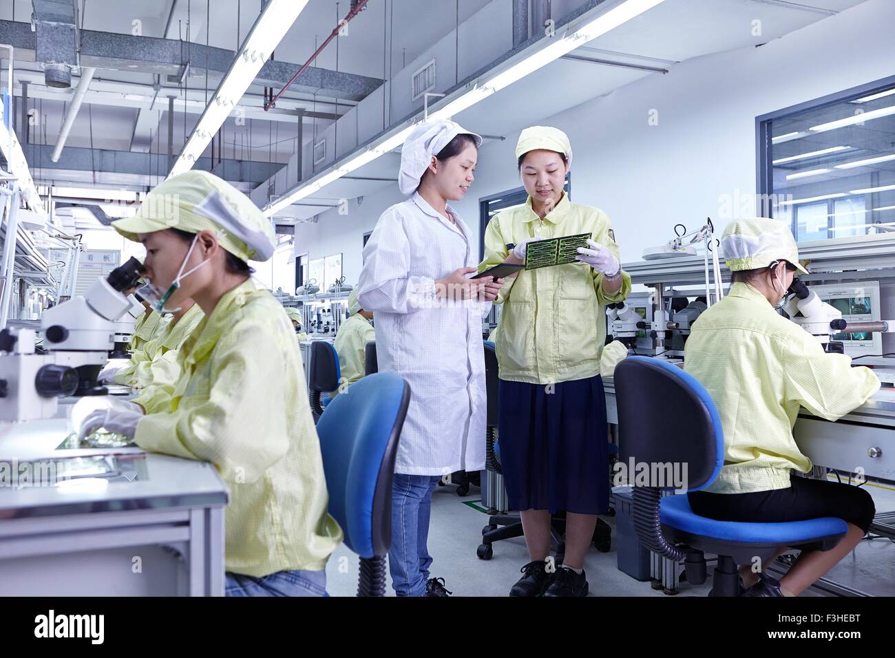 Supervisor overseeing work quality check station factory producing ...
