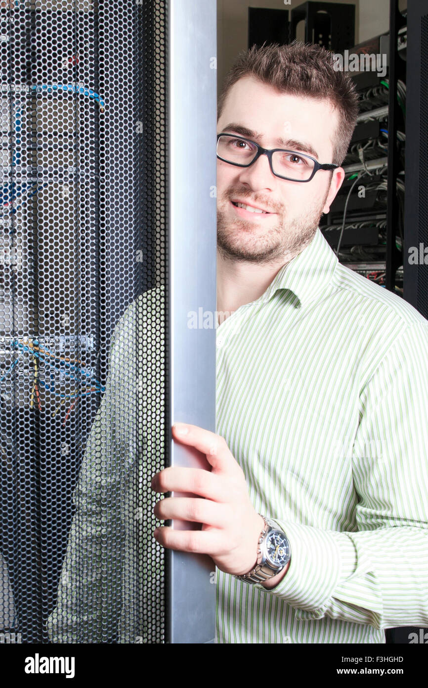 Network engineer working in server room Stock Photo - Alamy