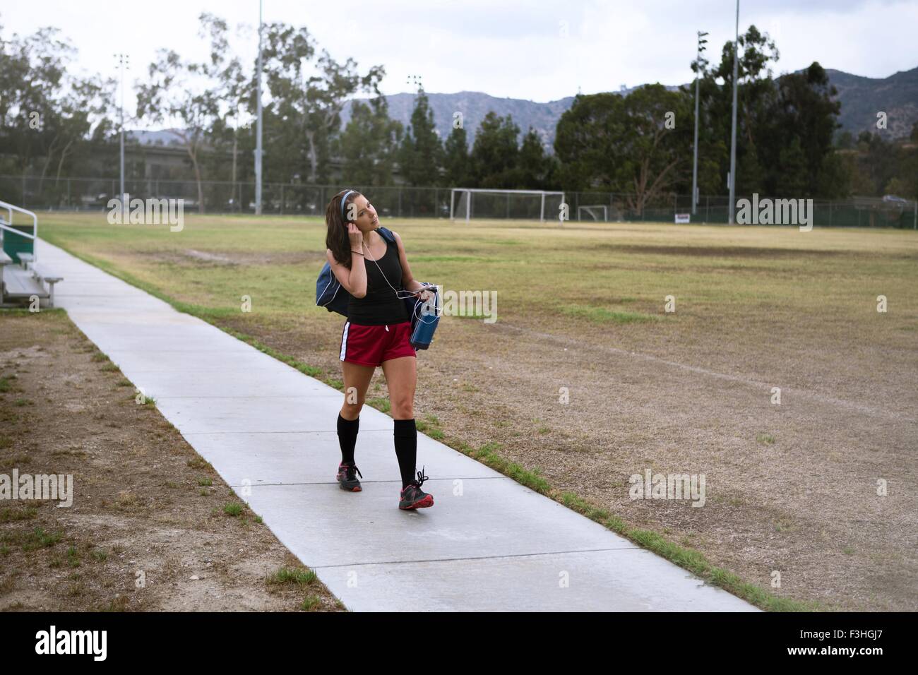 Soccer player using smartphone in field Stock Photo - Alamy