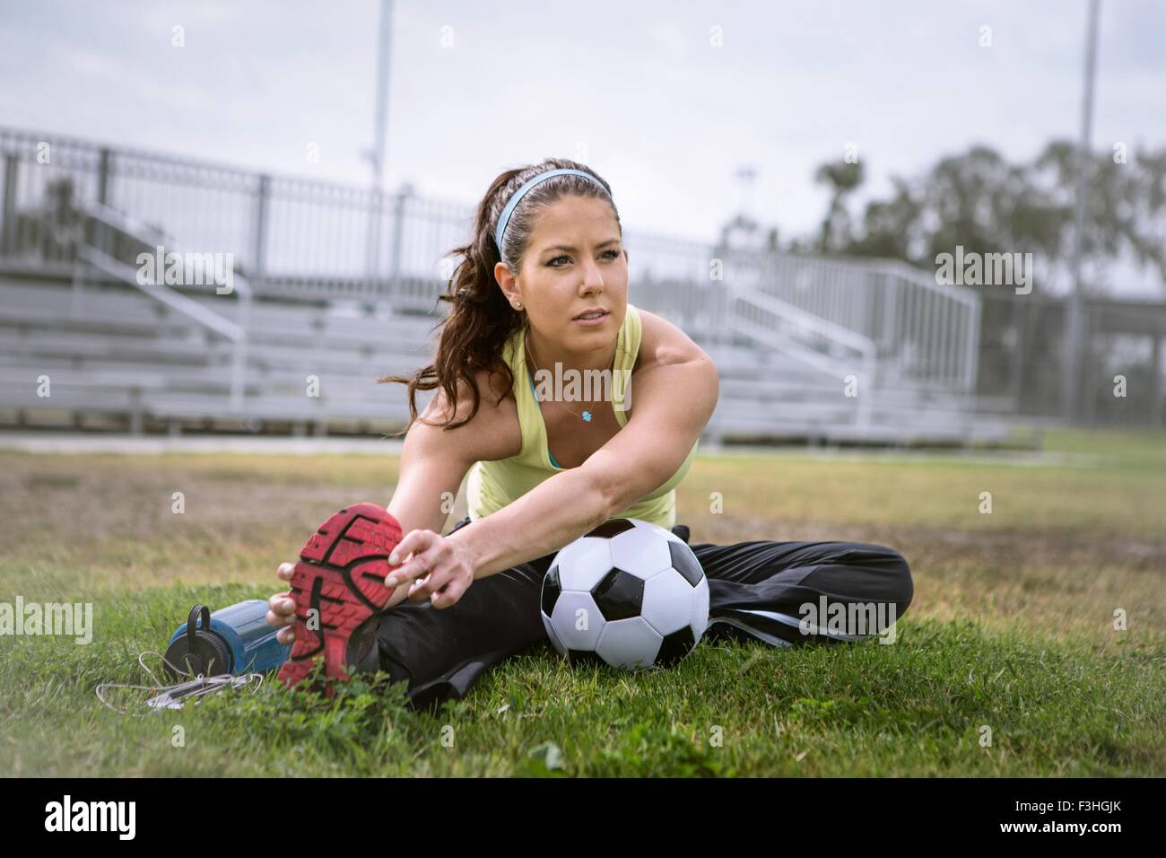 Soccer player stretching in field Stock Photo - Alamy