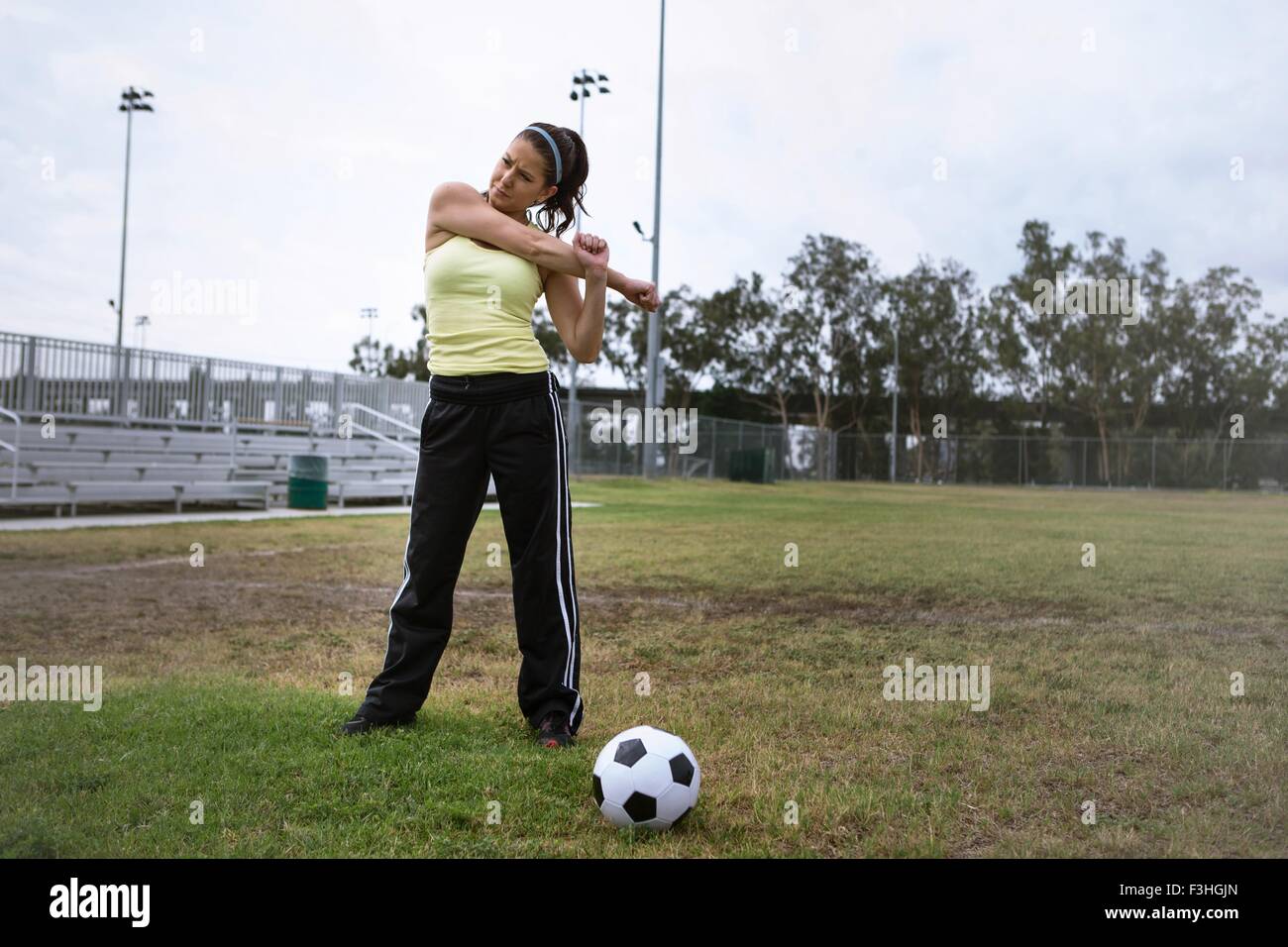 Soccer player stretching in field Stock Photo - Alamy