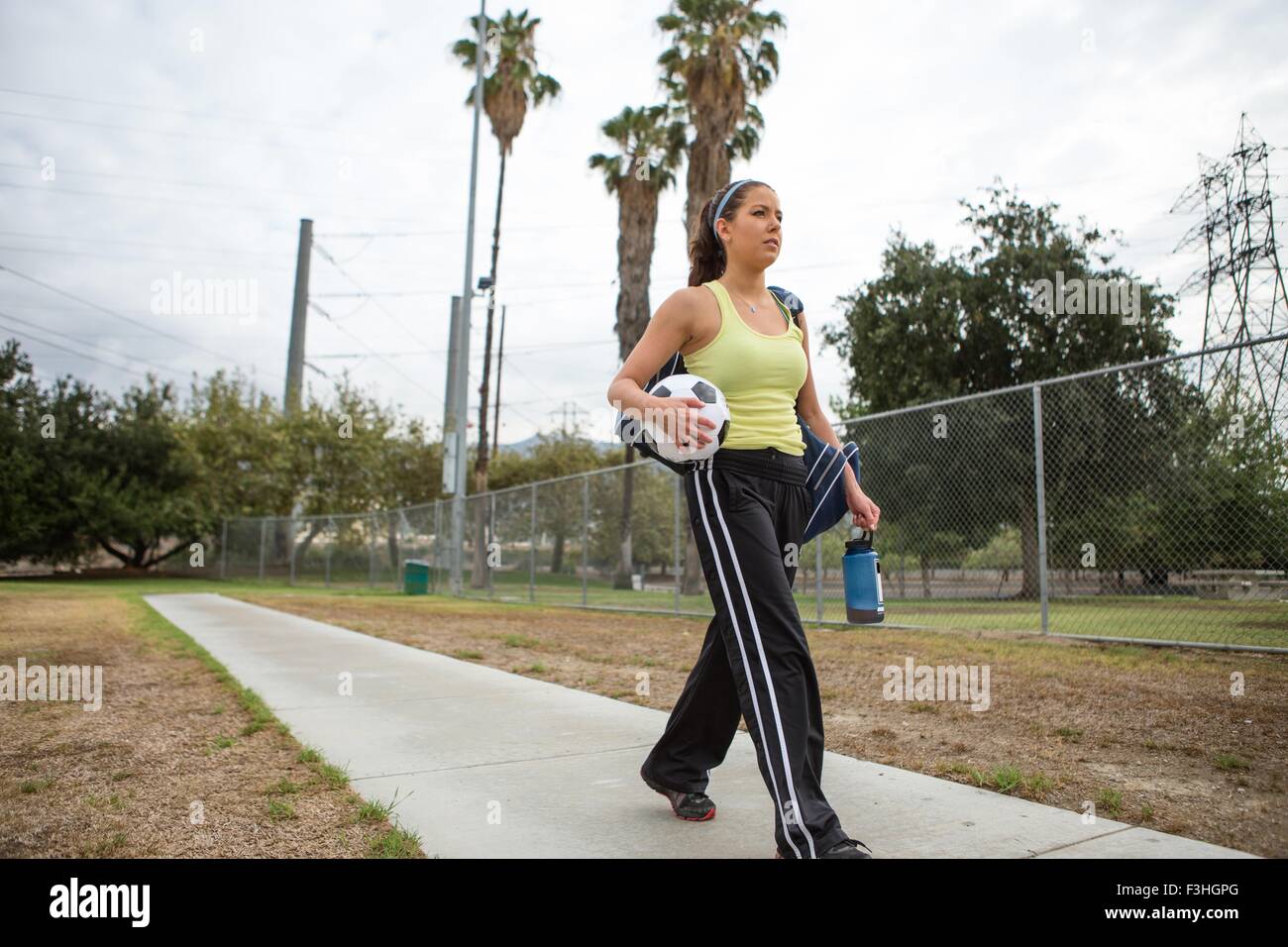 Soccer player leaving after practice in field Stock Photo - Alamy
