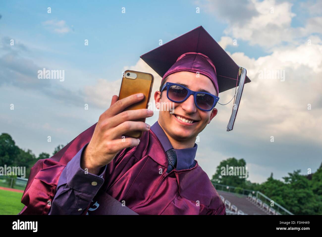 Graduate taking selfie with smartphone Stock Photo - Alamy