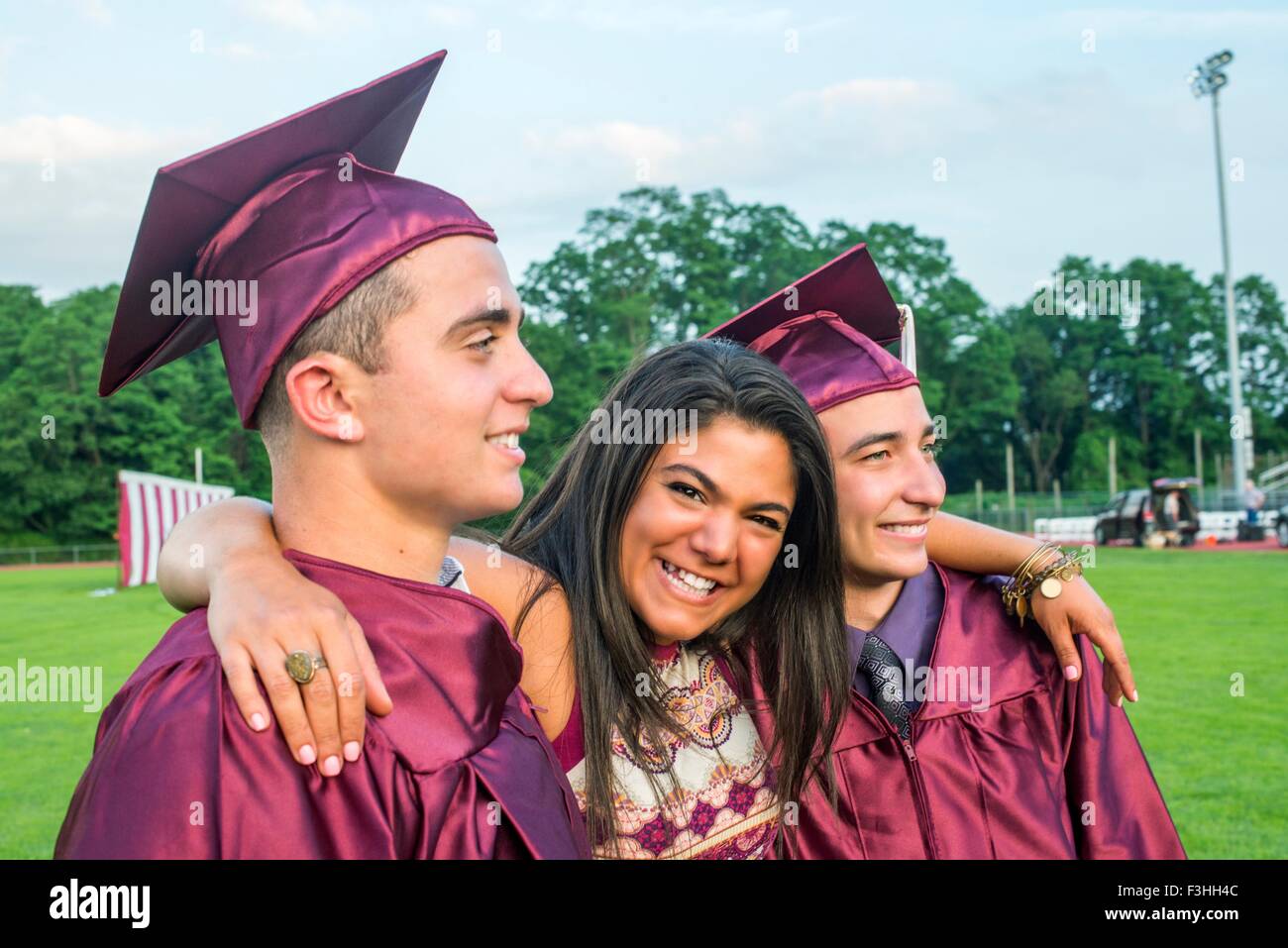 Students celebrate graduation with friend Stock Photo - Alamy