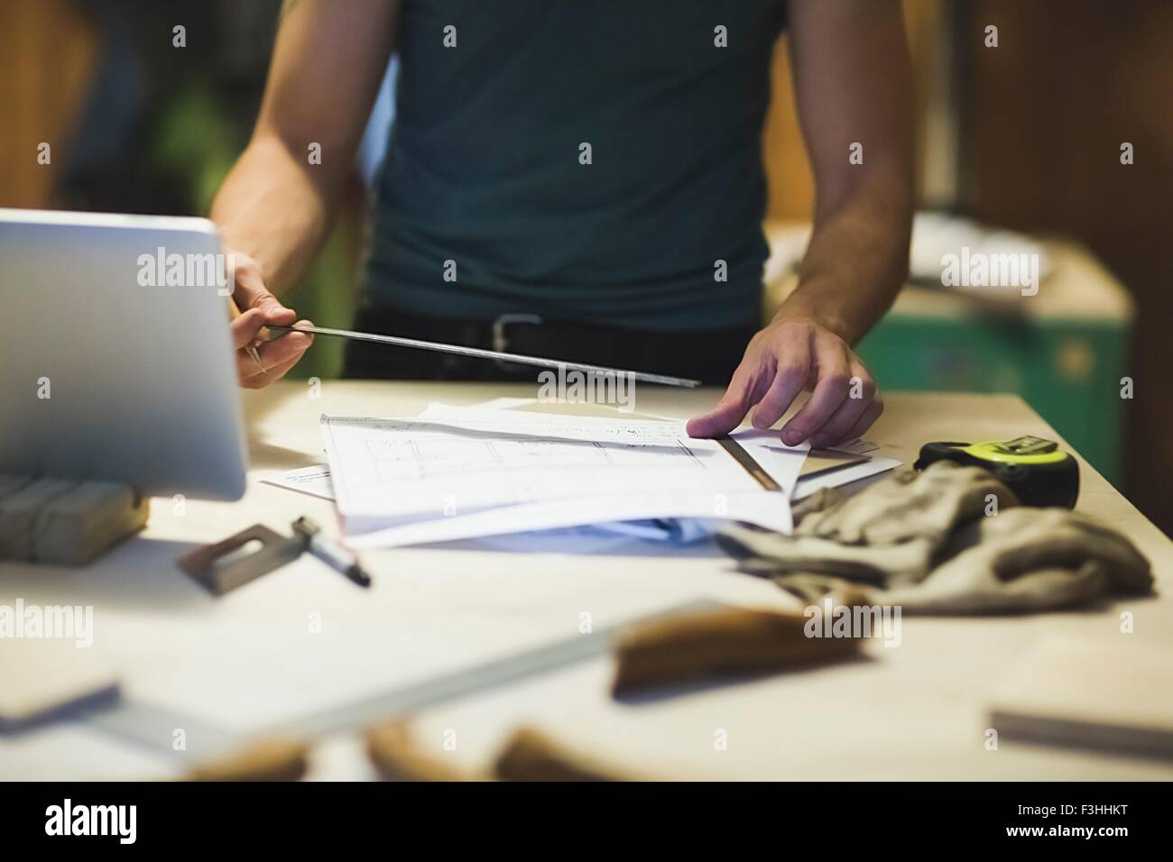 Cropped view of young mans hands using ruler Stock Photo - Alamy