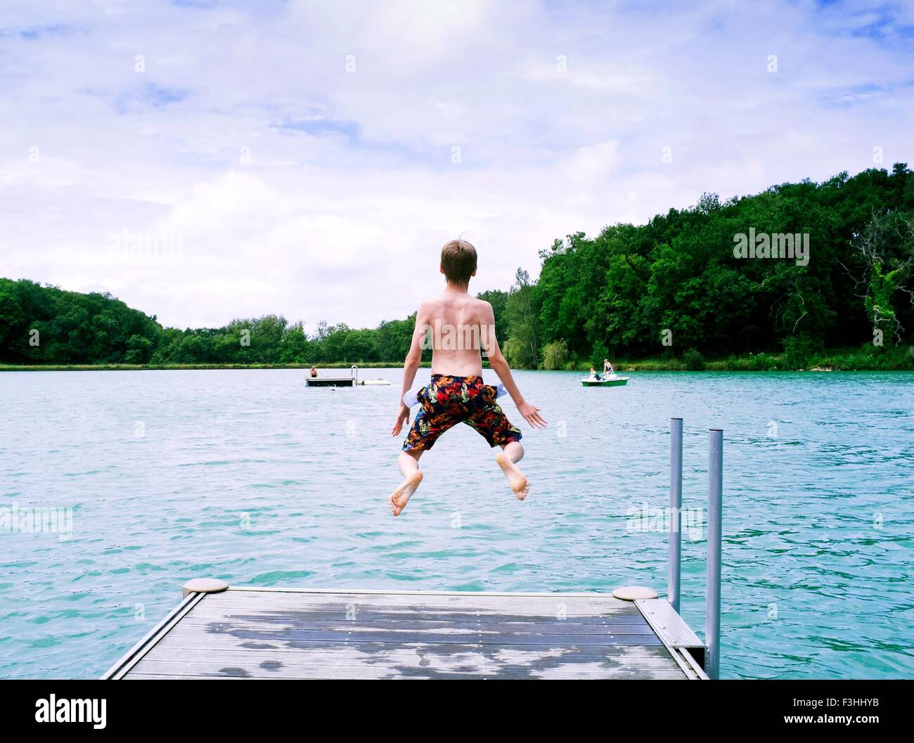 Boy jumping into lake hi-res stock photography and images - Alamy